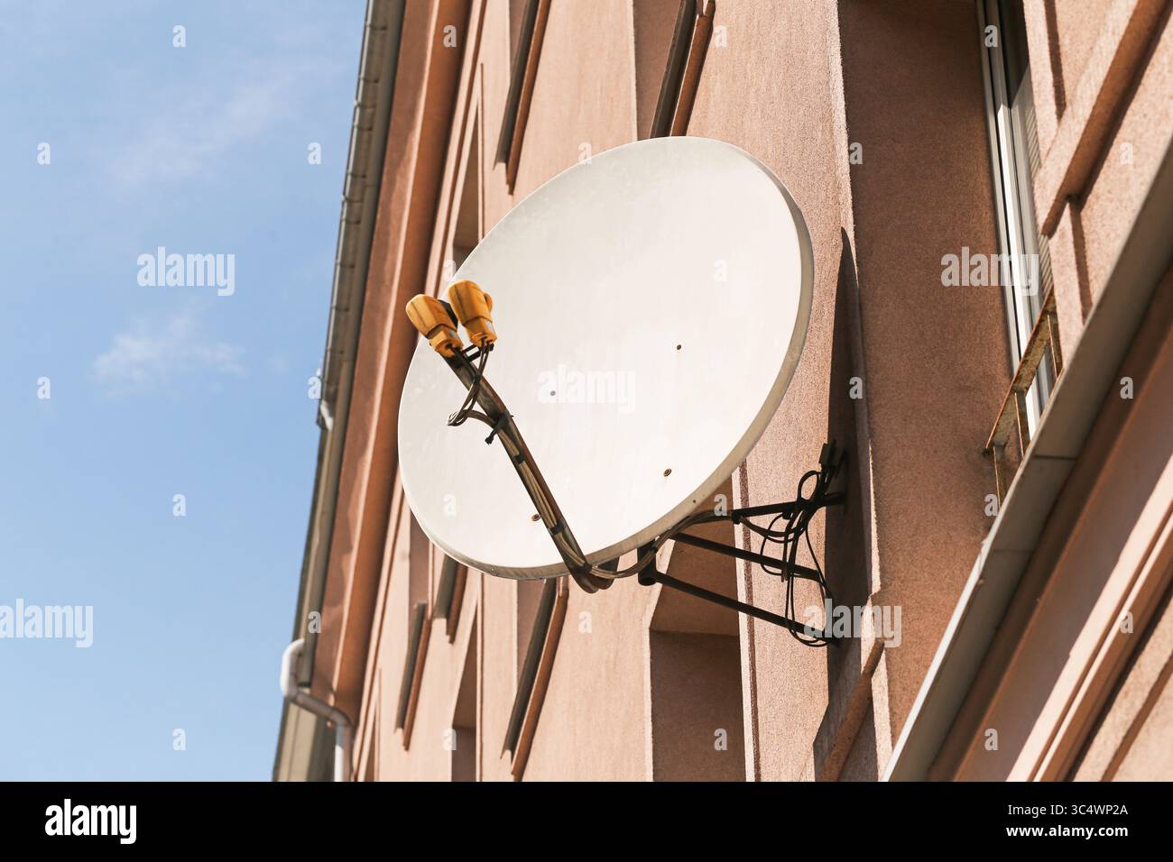 Satellite dish on building. Communication receiver on exterior wall ...