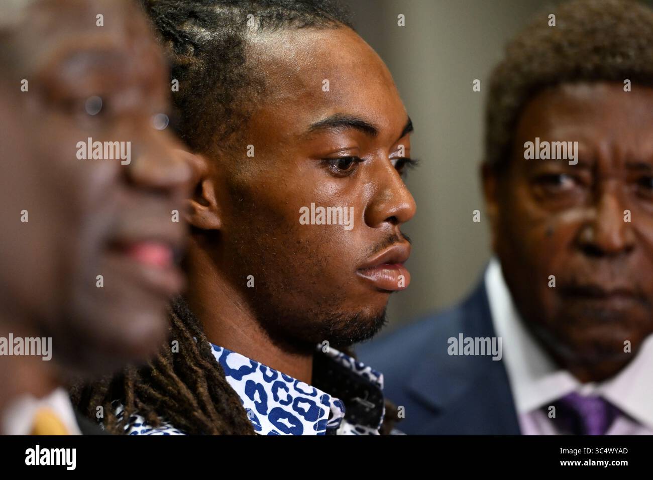 William McNeil Jr., center, looks on during a news conference Tuesday ...
