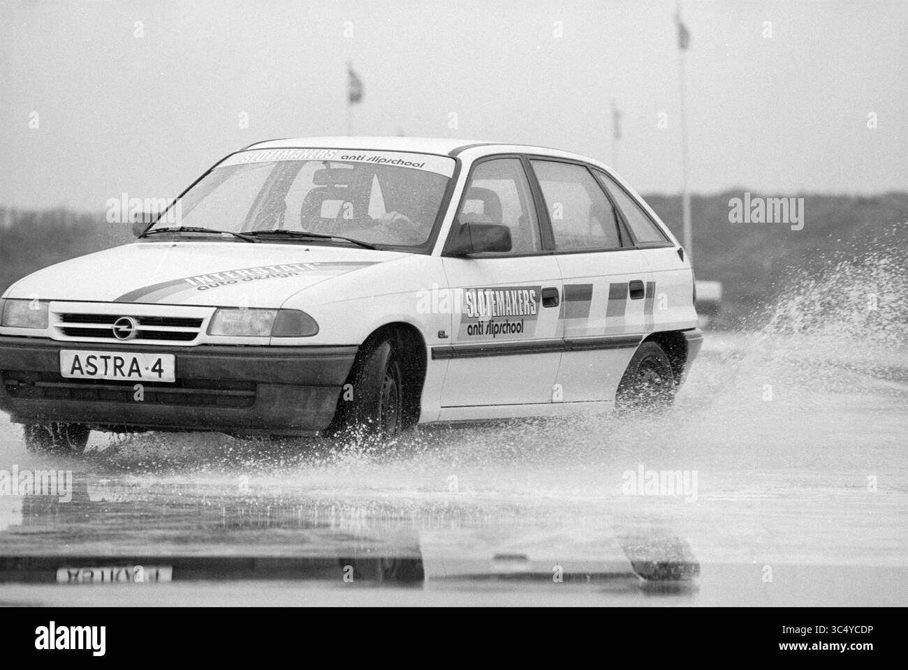 White hatchback car skids gracefully across hi-res stock photography ...
