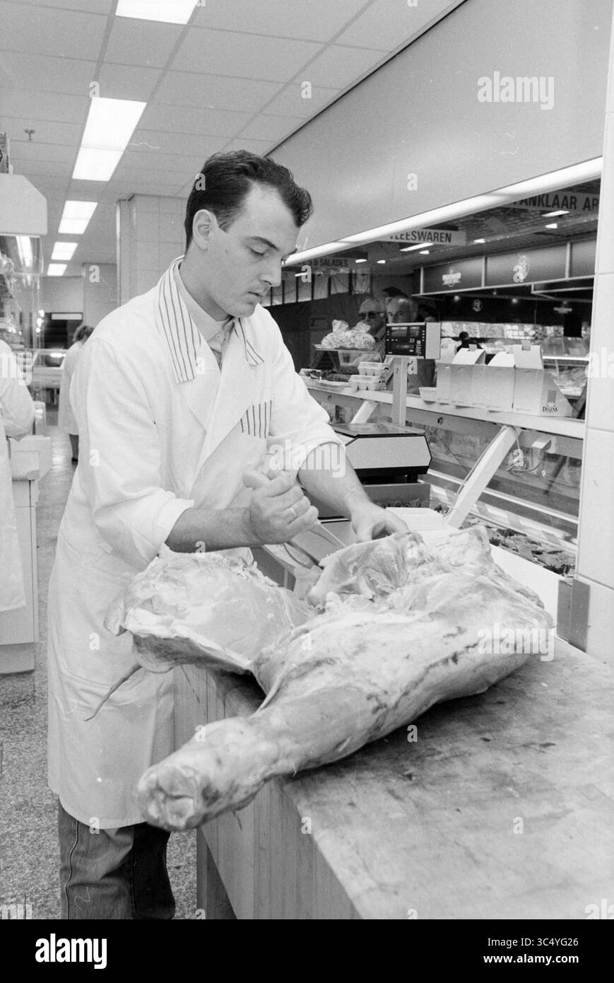 Butcher cuts meat in Black and White Stock Photos & Images - Alamy