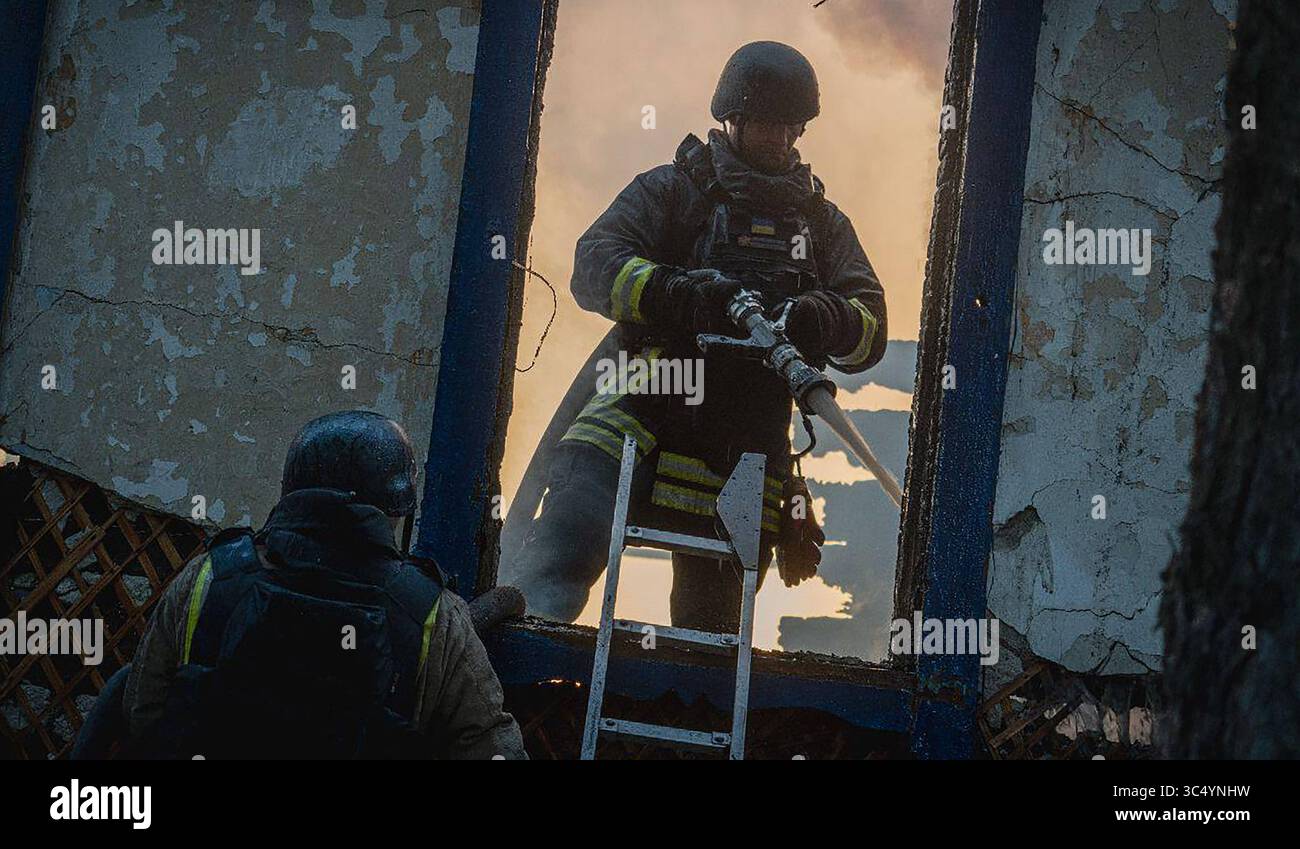 Ukrainian firefighters work to extinguish a fire followingmass Russian ...