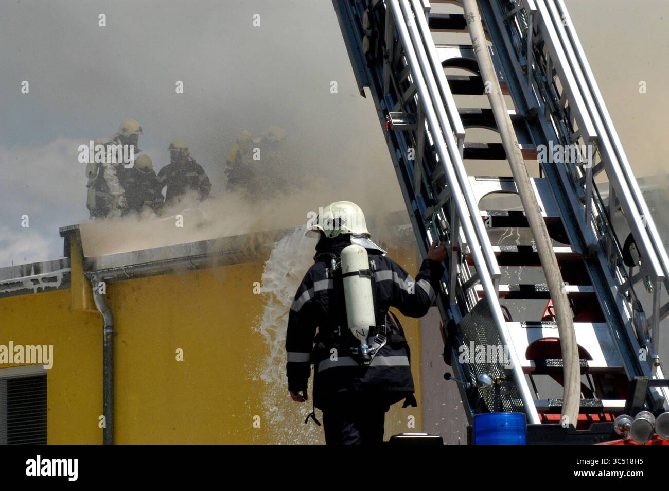 firefighter wearing protective clothing and respirator mask against ...