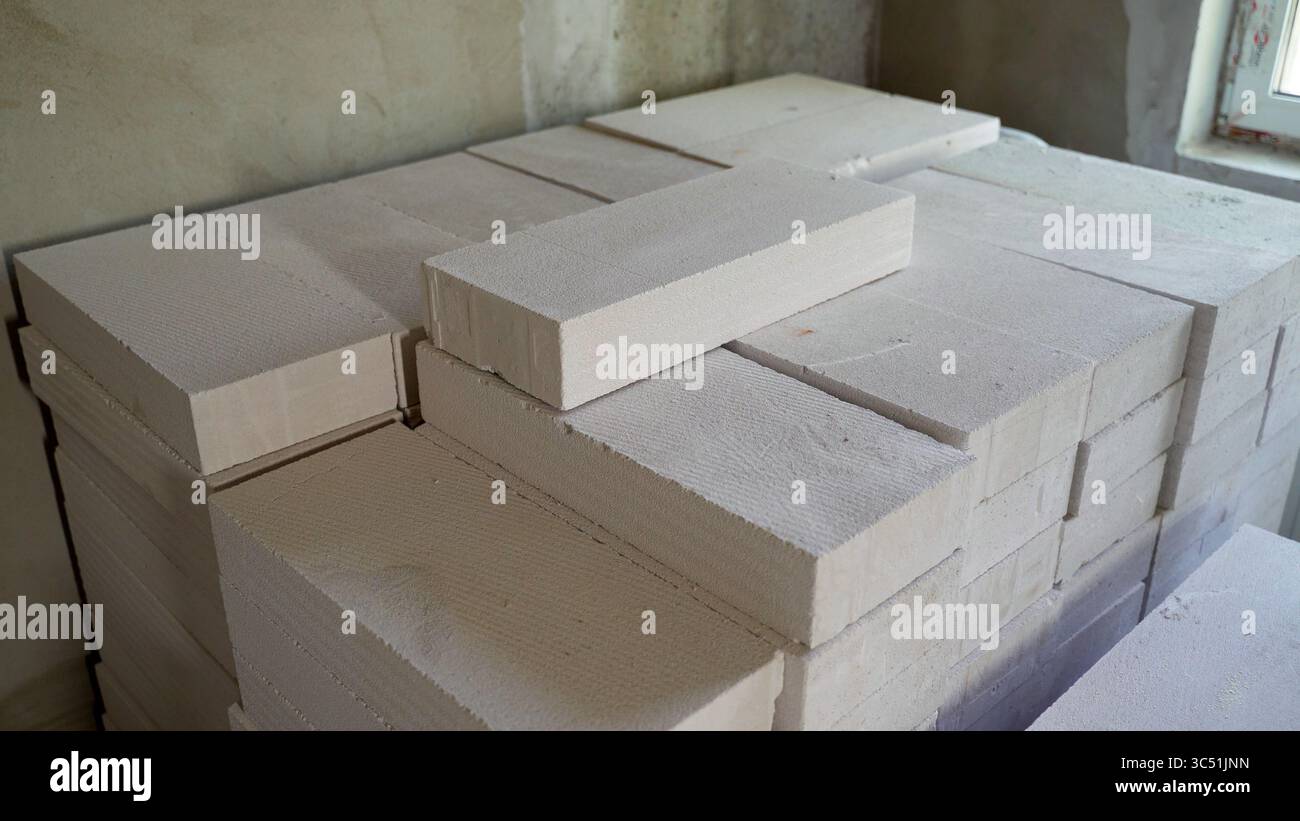 White aerated concrete blocks stacked neatly, ready for use in a ...