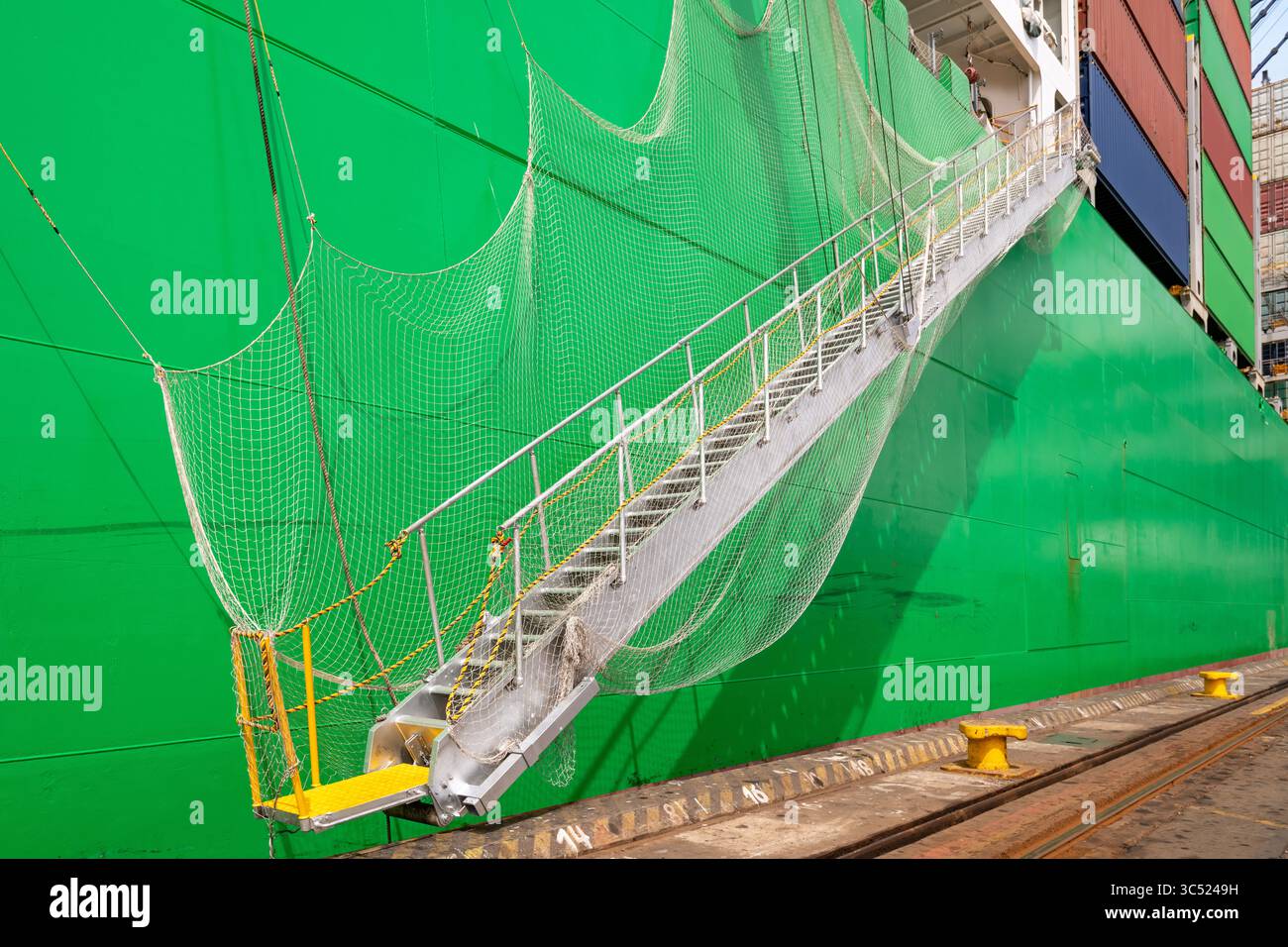 The robust gangway and safety netting of a large cargo ship, ready for ...