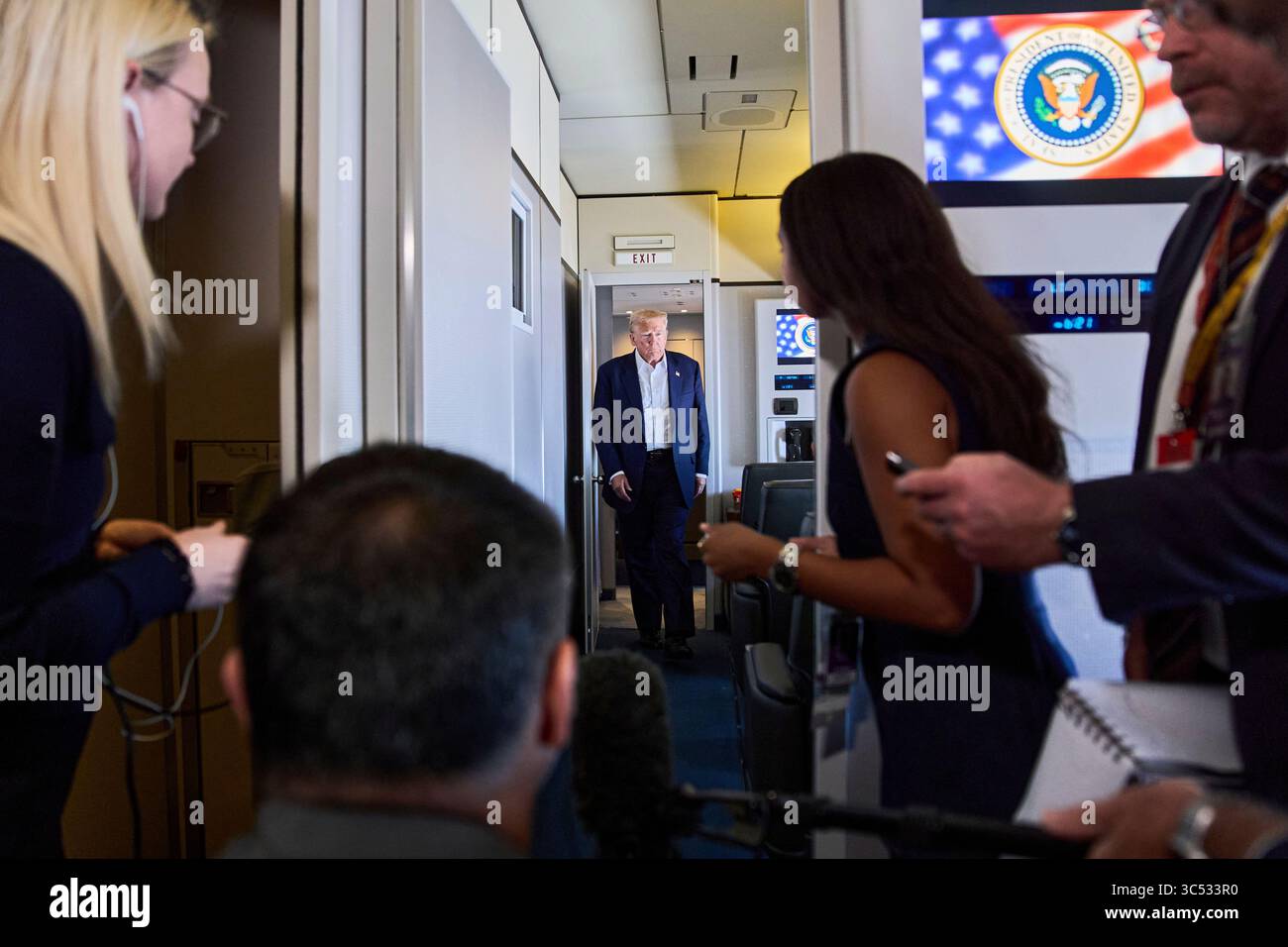 President Donald Trump walks through Air Force One to speak with ...