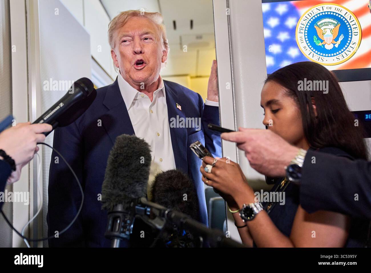 President Donald Trump speaks with reporters aboard Air Force One after ...