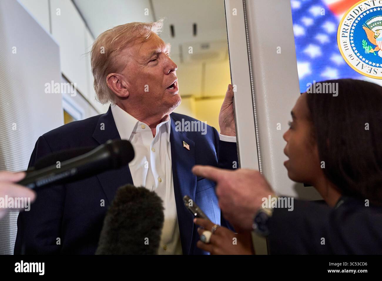 President Donald Trump speaks with reporters aboard Air Force One after ...