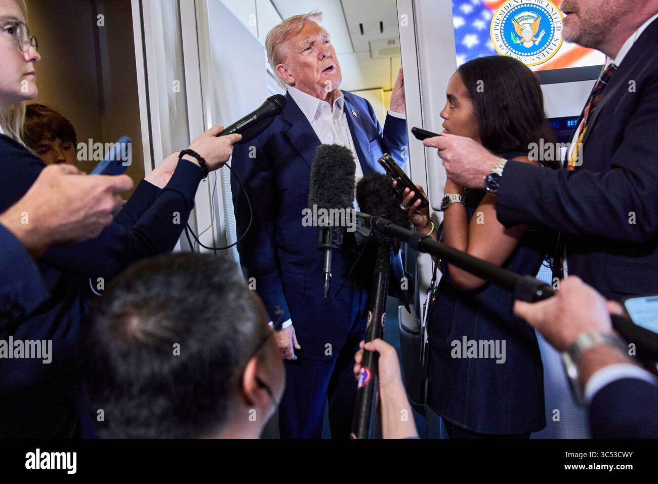 President Donald Trump speaks with reporters aboard Air Force One after ...