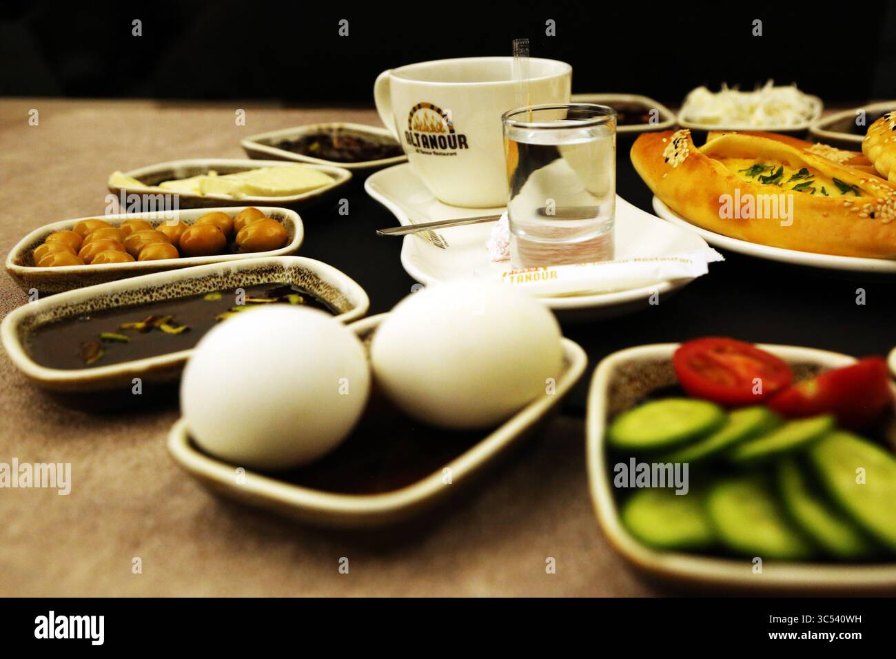 Middle Eastern breakfast table with fresh vegetables, boiled eggs, date ...