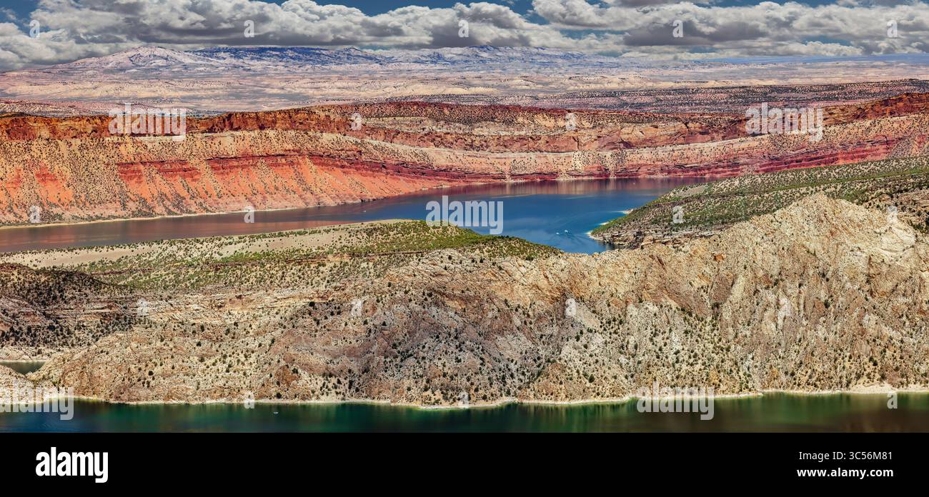 Vividly Banded Sedimentary Rock rises above the Blue Waters of Flaming ...