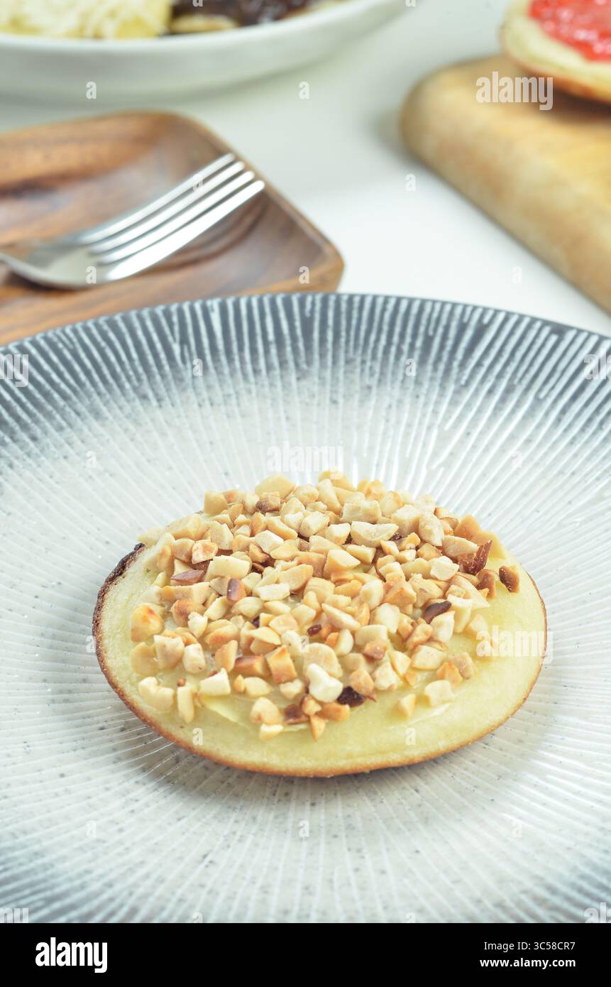 Serabi pancake with peanut topping and condensed milk, a traditional ...