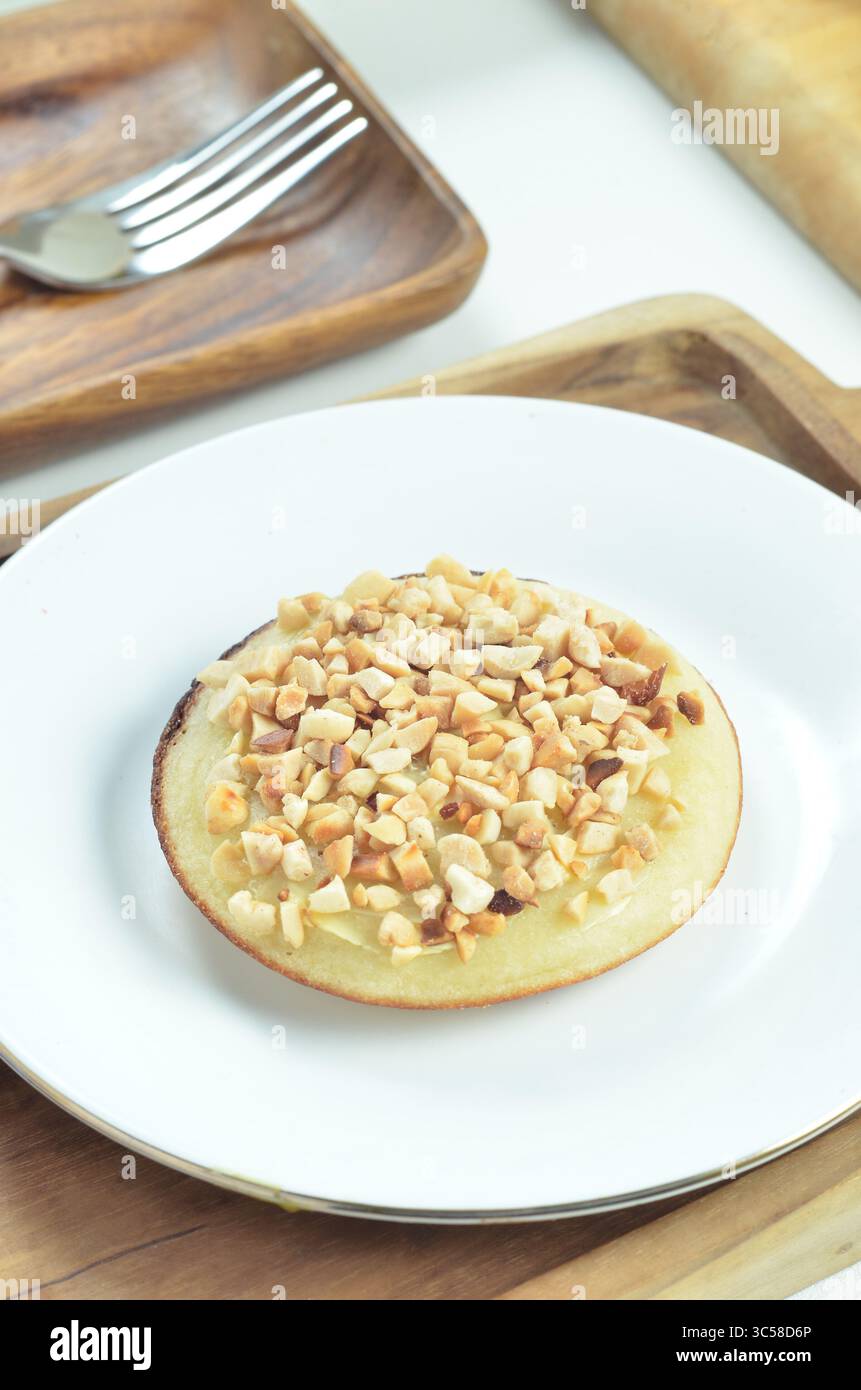 Serabi pancake with peanut topping and condensed milk, a traditional ...