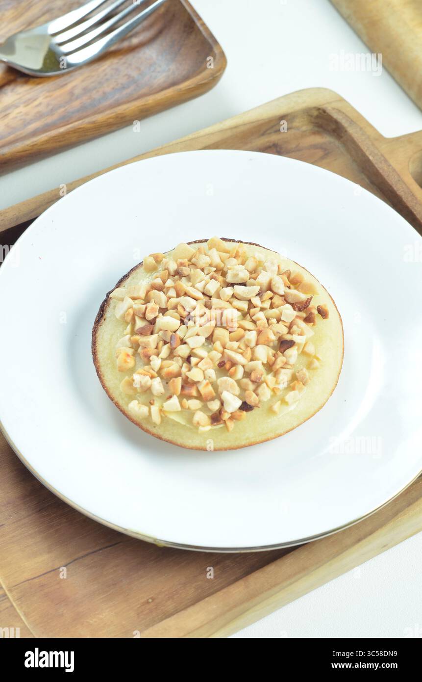 Serabi pancake with peanut topping and condensed milk, a traditional ...
