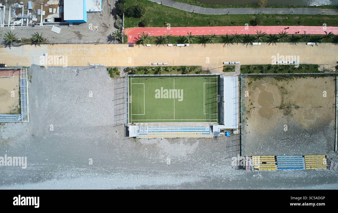 Top view of a football field and a path with palm trees in Batumi ...