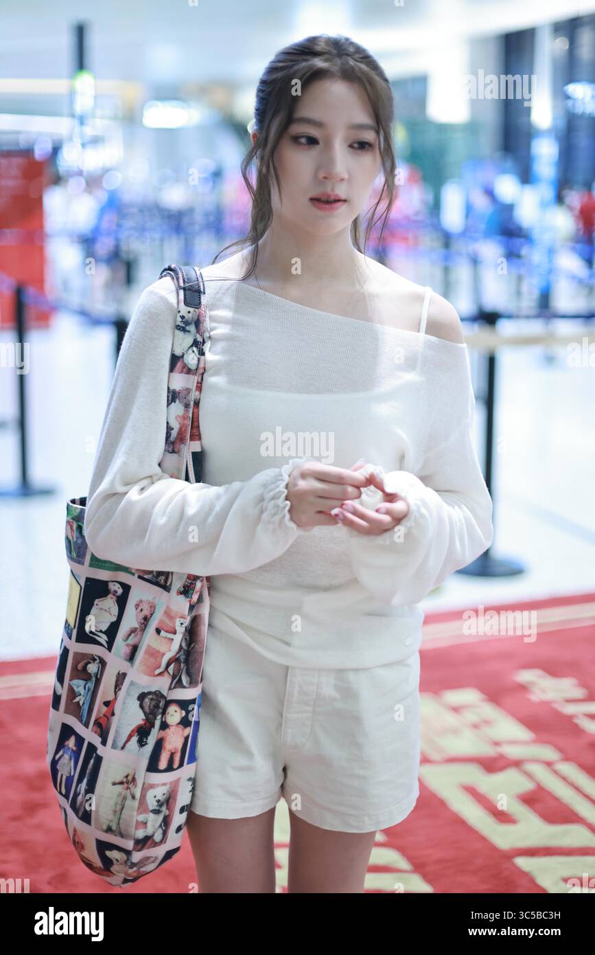 Taiwanese singer and member of girl group Gen1es Ouyang Didi appears at the airport in Shanghai ...
