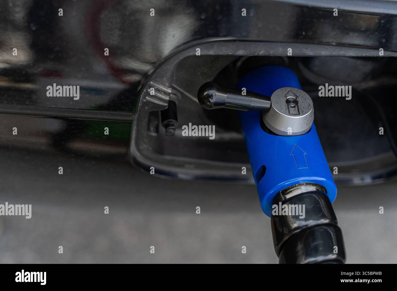 Close-up of a compressed natural gas (CNG) refueling nozzle attached to ...