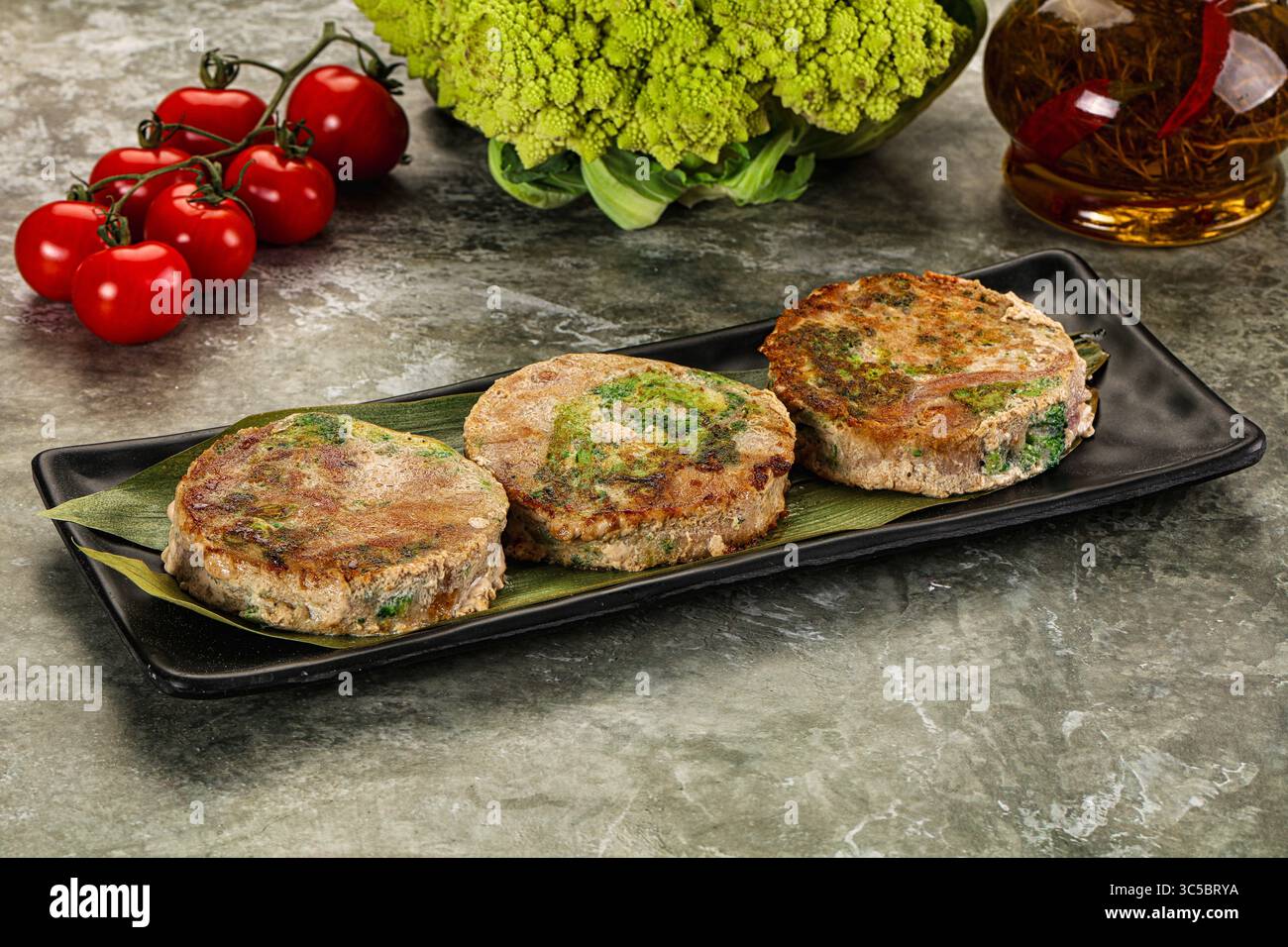 Roasted tuna medallion with broccoli cabbage Stock Photo - Alamy