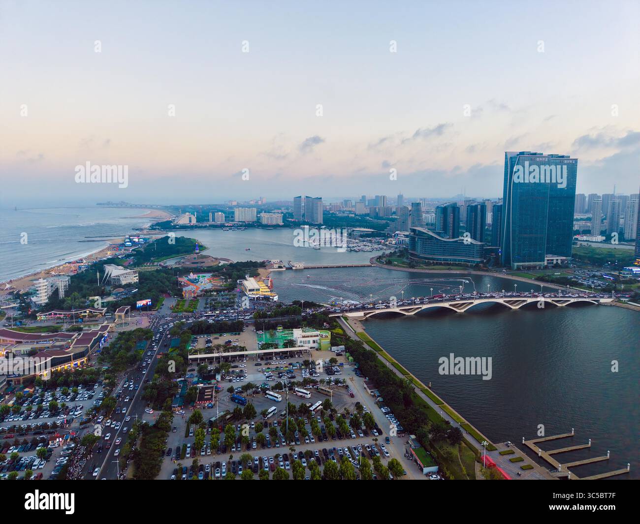Aerial photo shows tourists playing at the seaside in Rizhao City, east ...