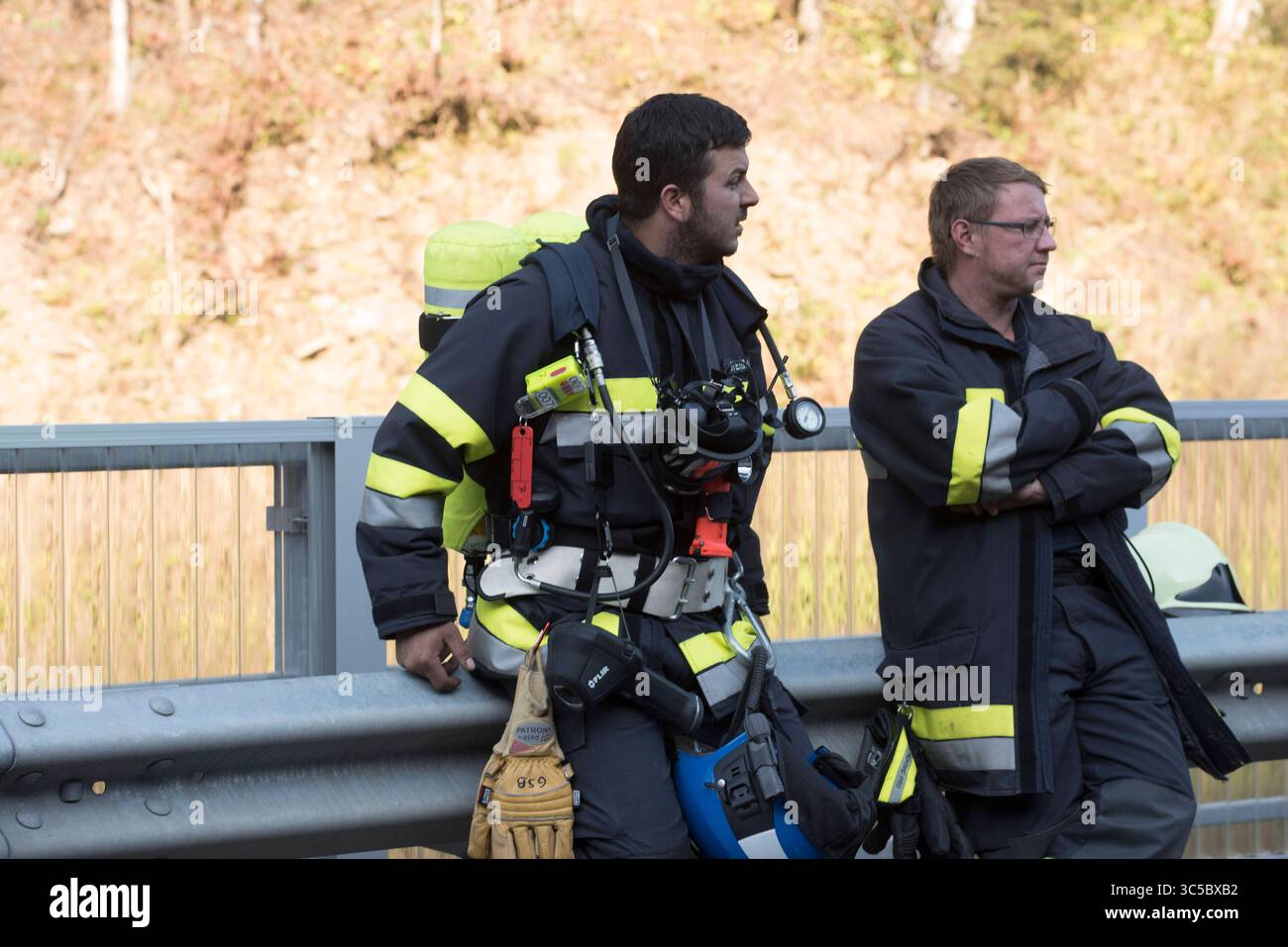 firefighter wearing protective clothing and respirator mask against ...