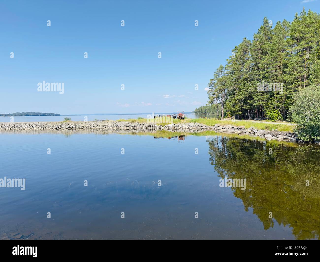 A stunning view of a calm lake, perfect weather reflecting the vibrant ...