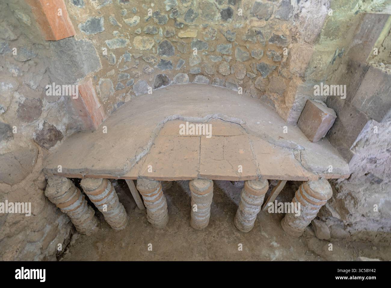 Hypocaust heating system with brick pilae supporting the floor in the ...