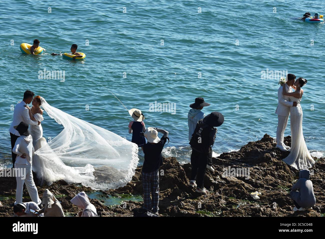 Tourists enjoy the summer time on the beach of Fujiazhuang Park in ...