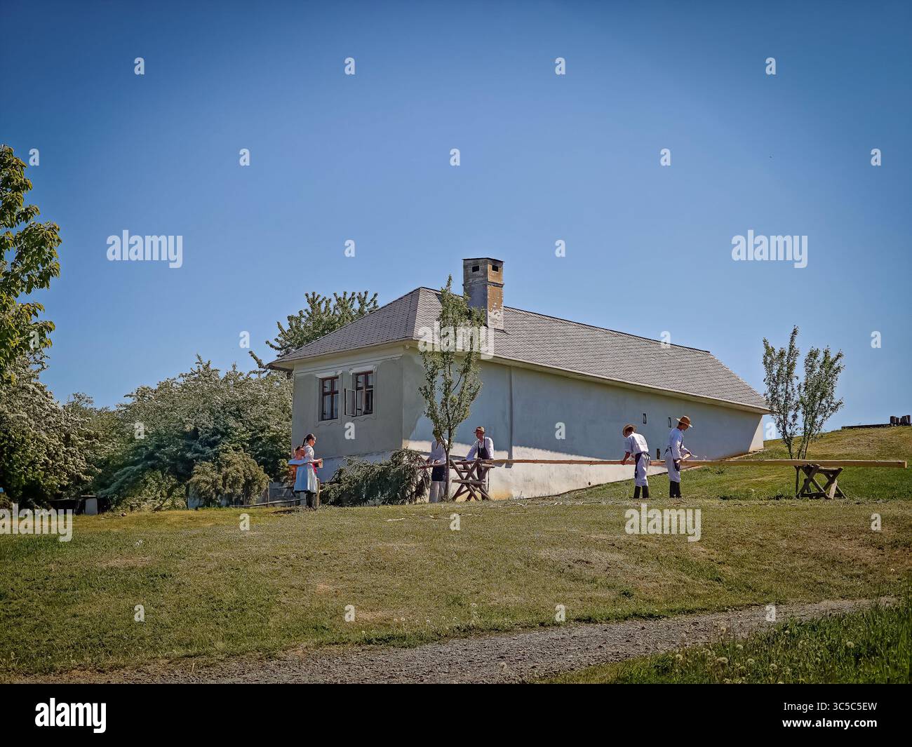 Traditional rural house in South Moravia with people in folk costumes ...