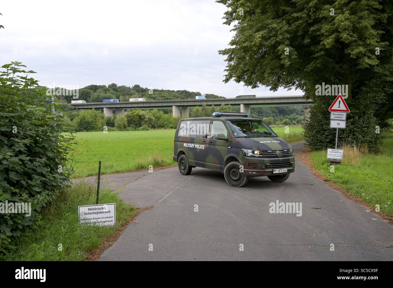 30 July 2025, Saxony, Bahren: A military police vehicle and cordon ...