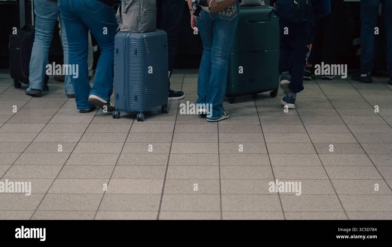 Crowd of legs walking with suitcases at terminal during refugee-like ...