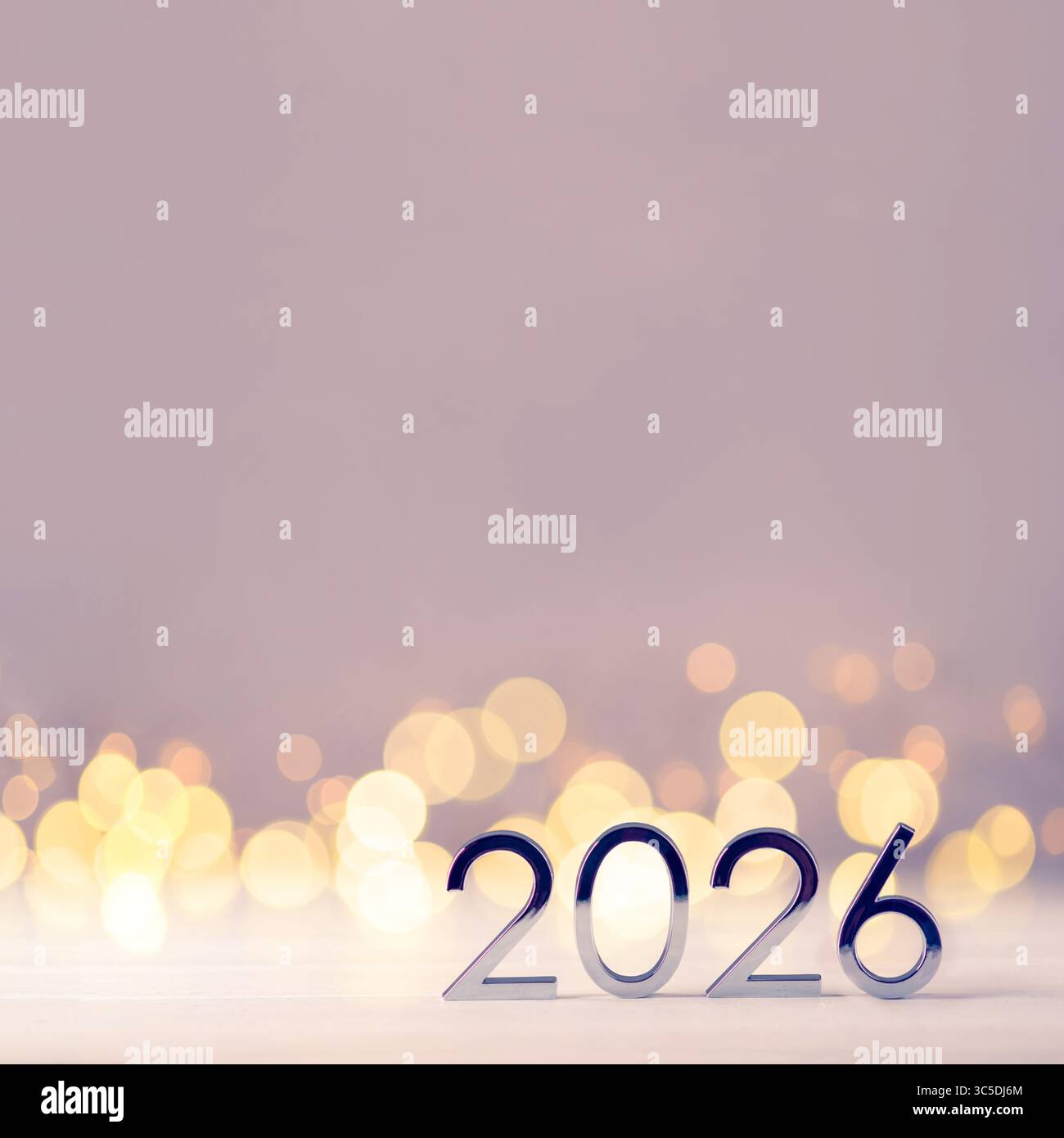 Metal numbers 2026 on a white table with Christmas trees and bokeh lights. Happy New Year 2026 ...