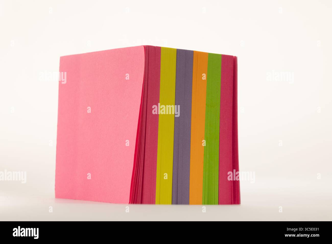 A stack of colorful sticky notes is prominently displayed against a ...