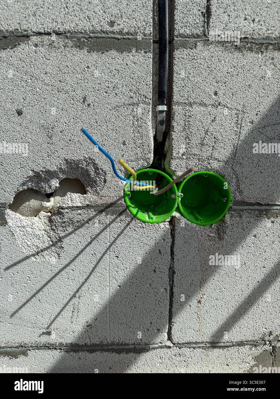 Bunched electric wires inside junction box. Detail from early stage of apartment electrical work ...