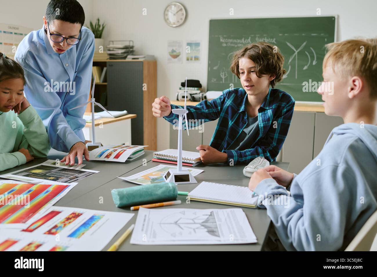 Teenage Students Collaborating on Science Project with Teacher in ...