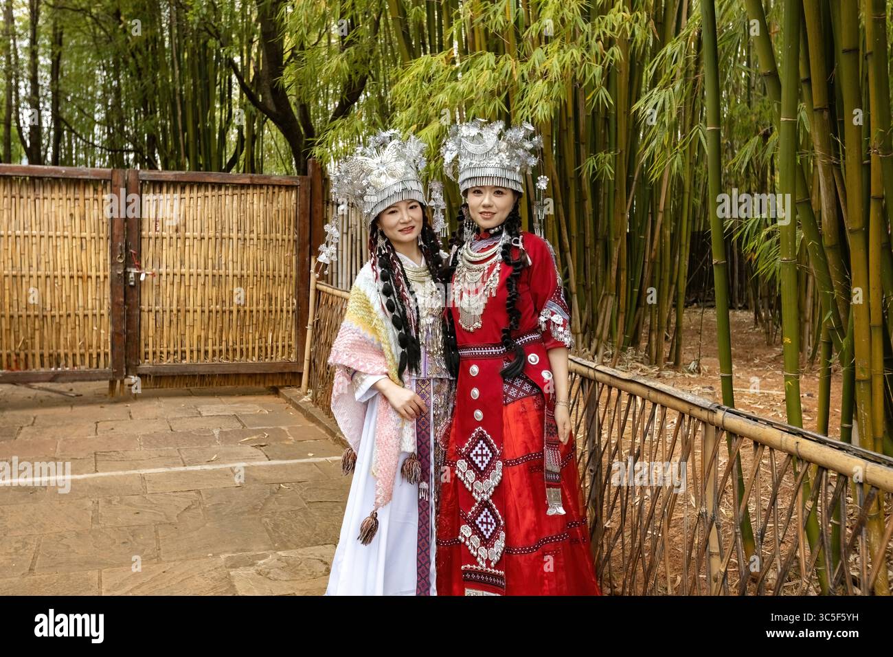 Women in traditional ethnic costumes with elaborate silver headdresses ...