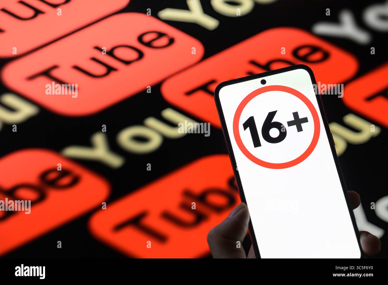 The YouTube logo is being displayed on a mobile phone with YouTube seen ...