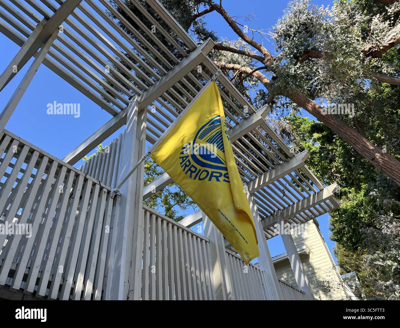 Golden State Warriors flag displayed beneath a slatted wooden structure ...