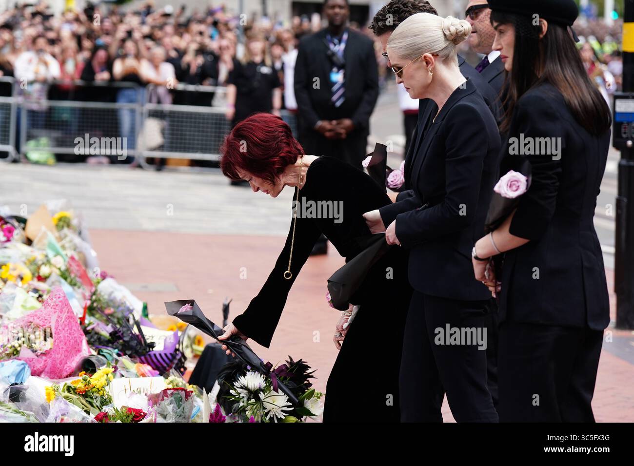 Sharon Osbourne with family members lay flowers and view the messages ...