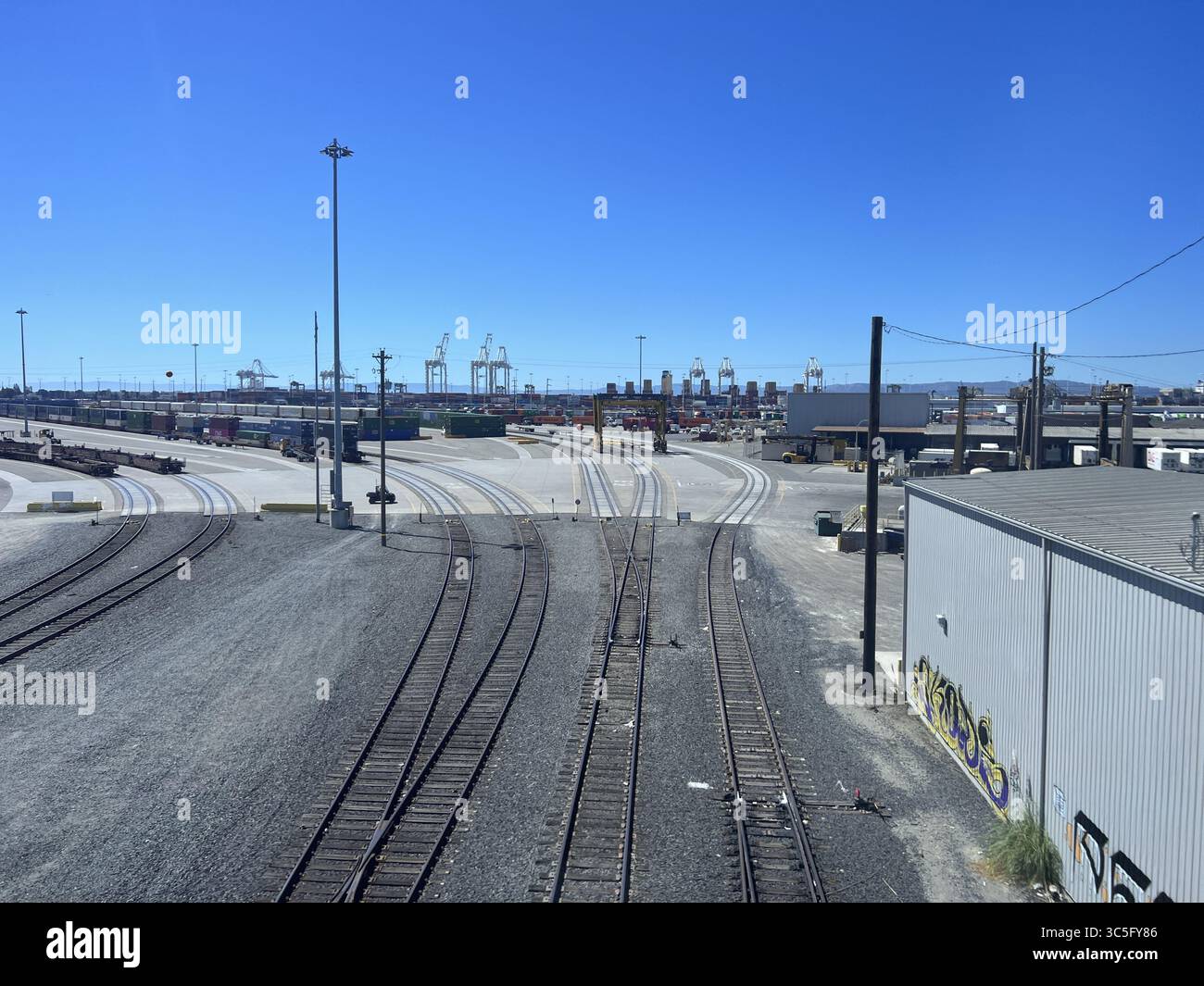 Freight yard with multiple train tracks and shipping cranes in the ...