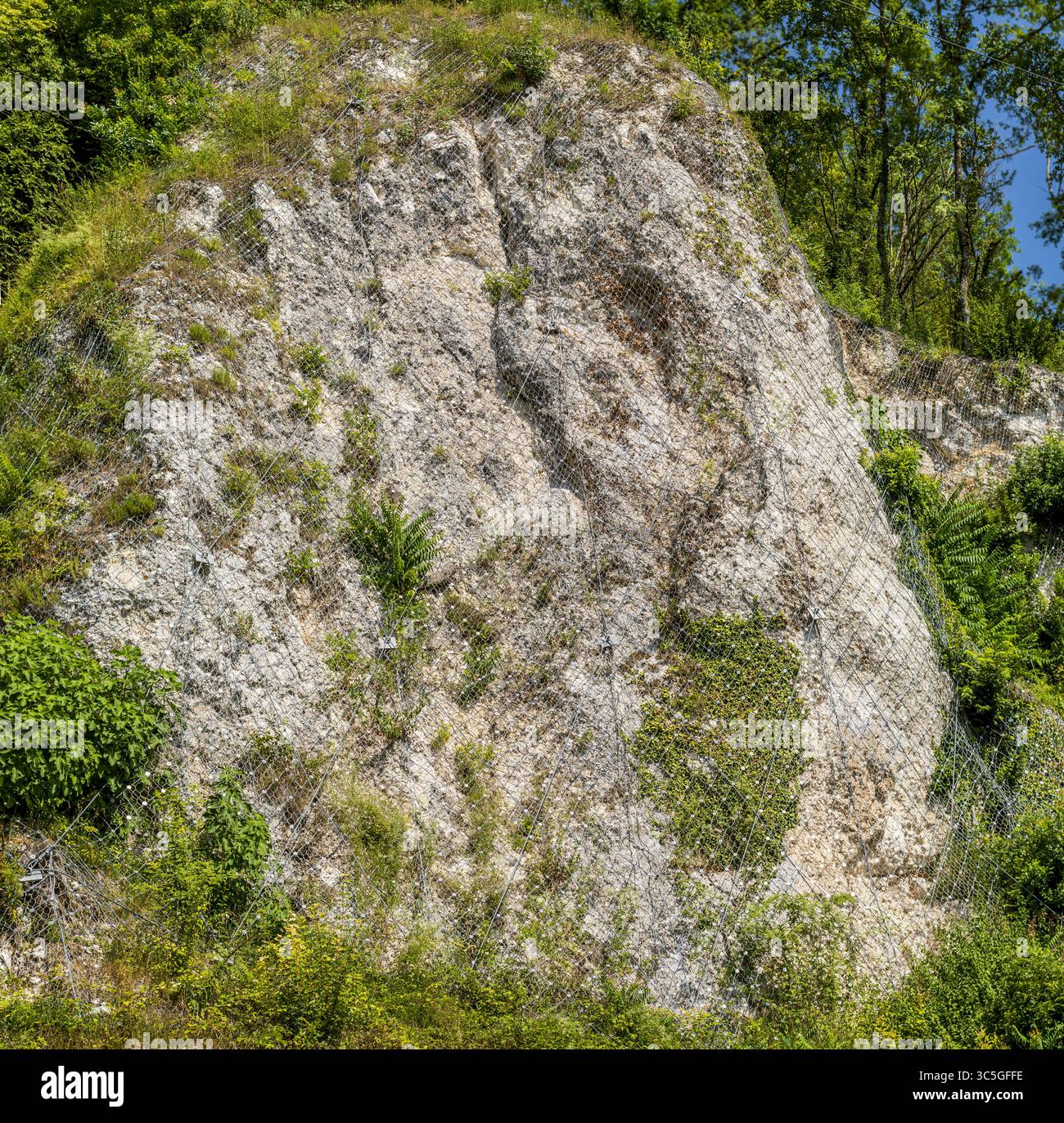 rock surface wrapped with protective metallic wire mesh,wide shot Stock ...