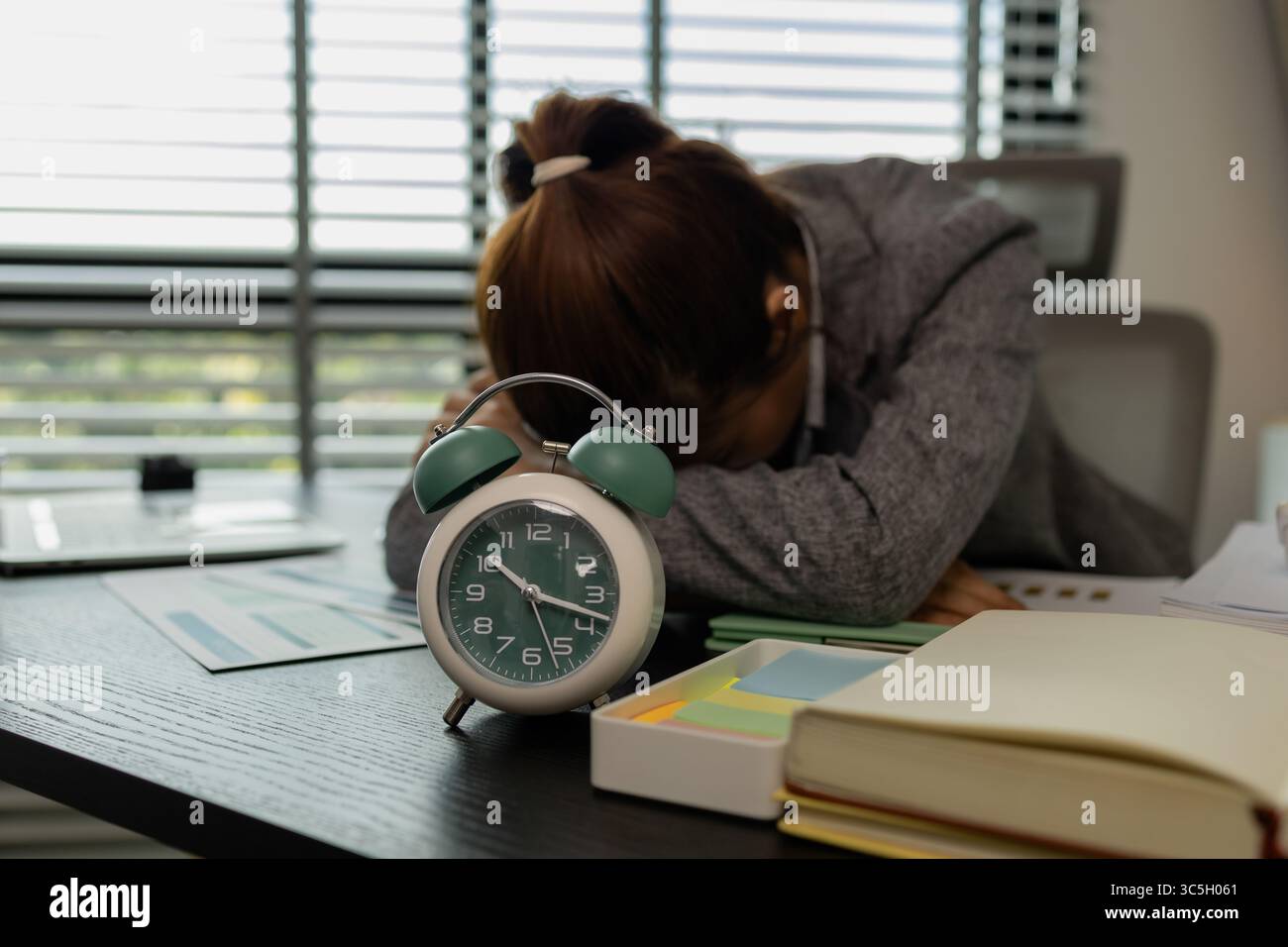 a female employee is feeling very stressed and tired form work, a ...