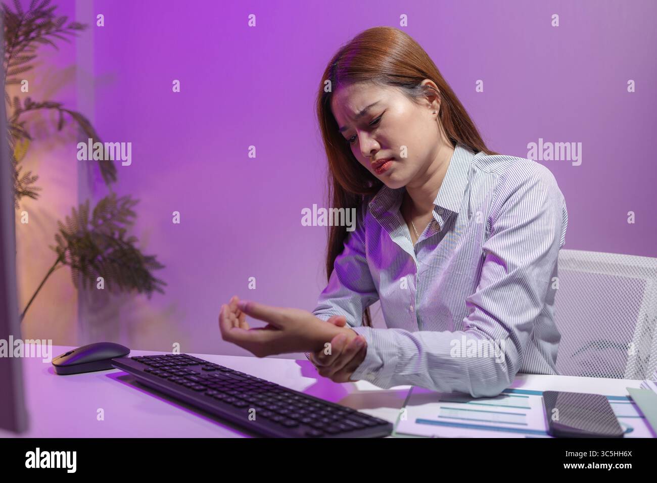 an employee sits in the office for a long time because she has to work ...