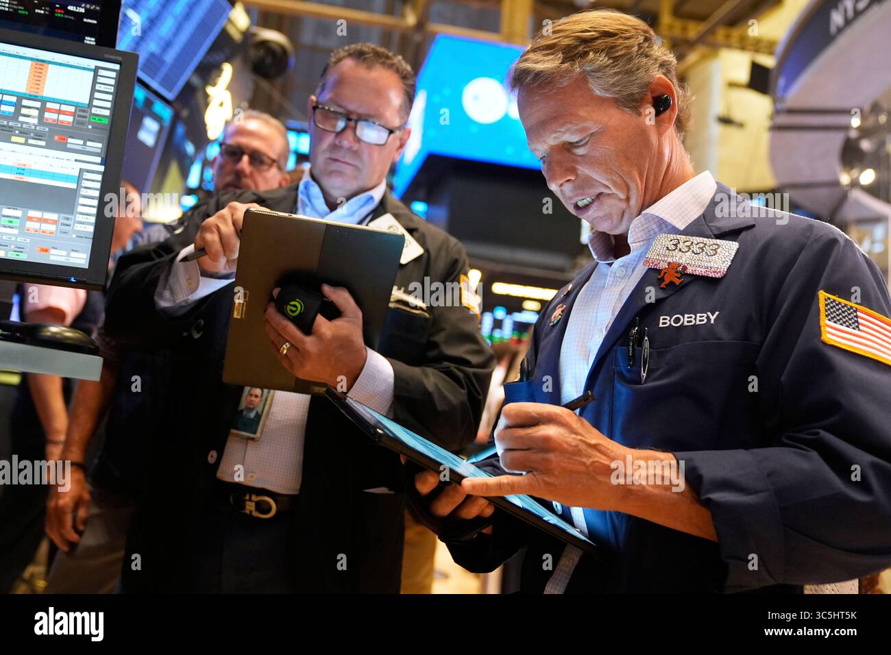 Robert Charmak, right, works on the floor at the New York Stock ...