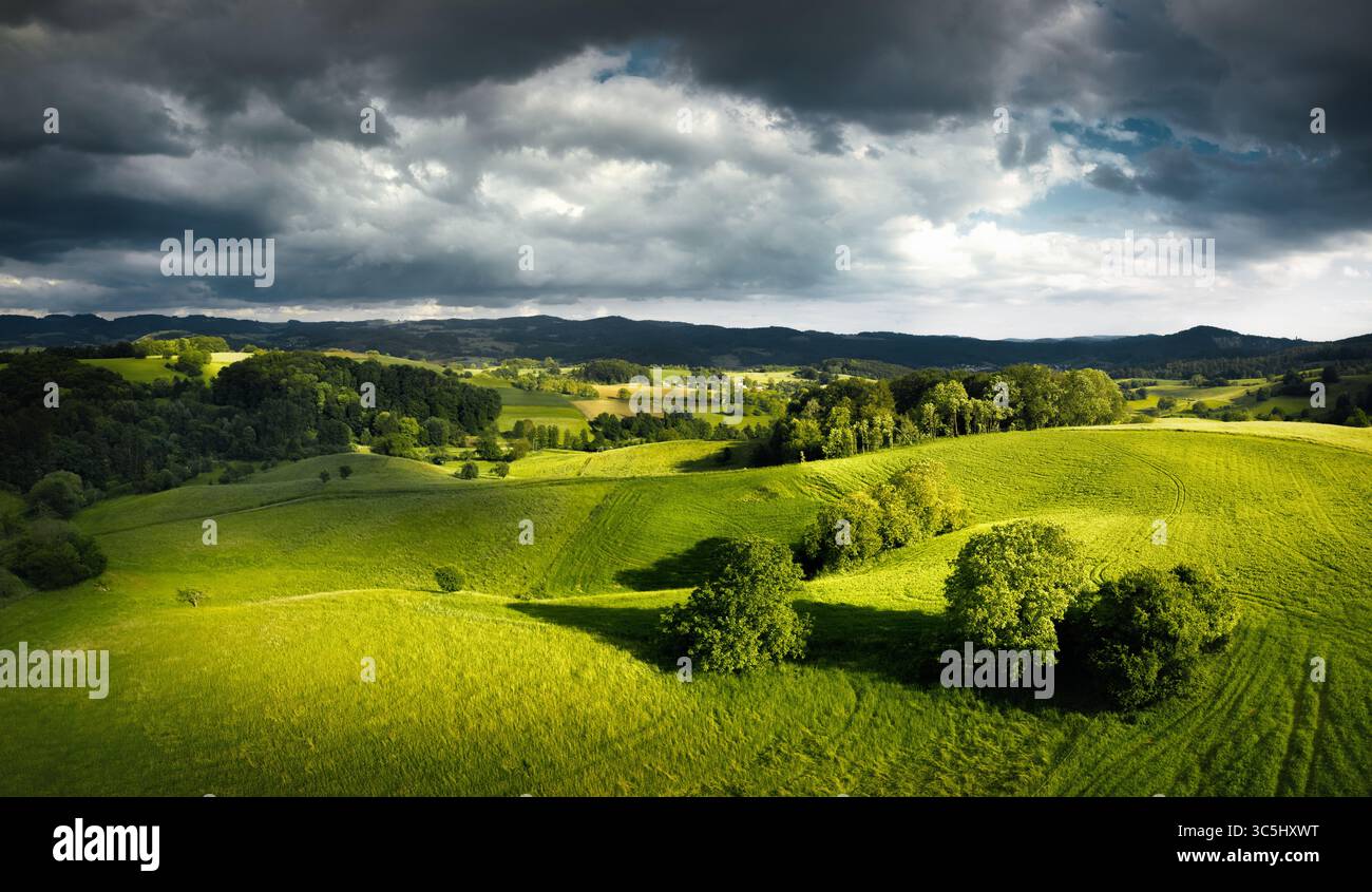 Aerial view of green rolling hills in beautiful dramatic light, with ...