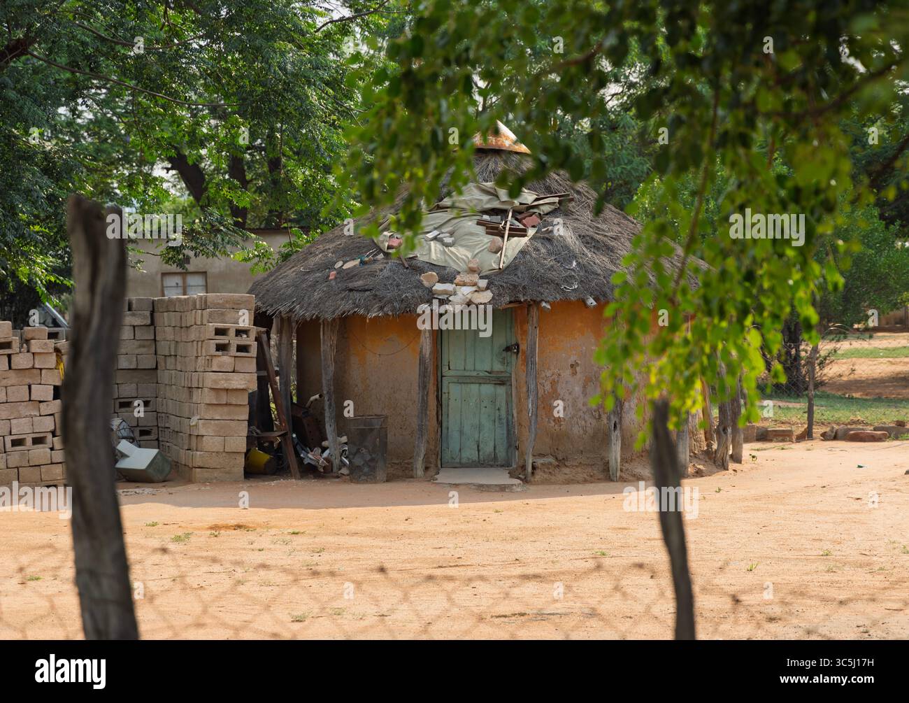 african mud hut with thatched roof, old dilapidated, poverty in the ...
