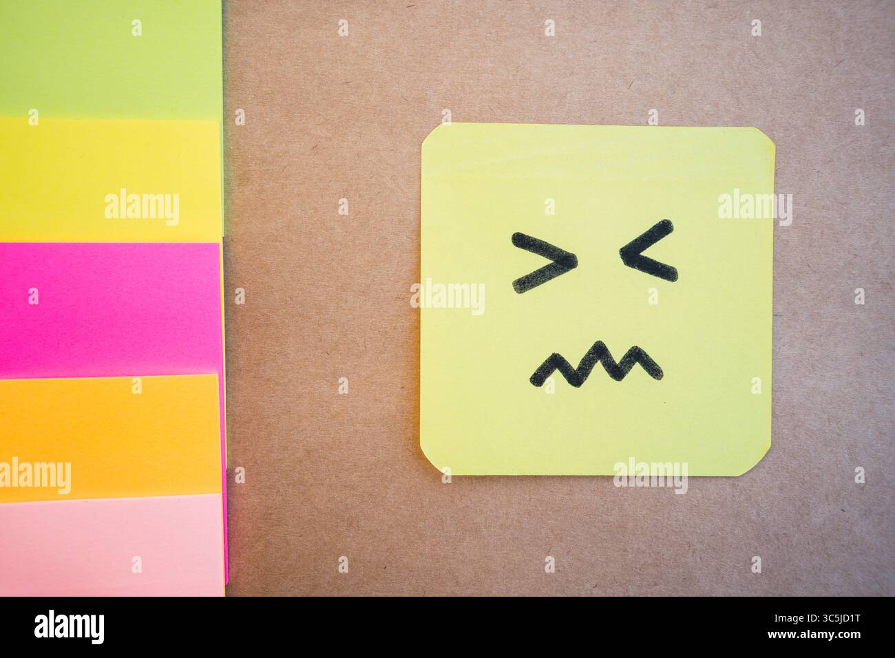 Sick face drawn on colored paper with black marker with a solid uniform ...