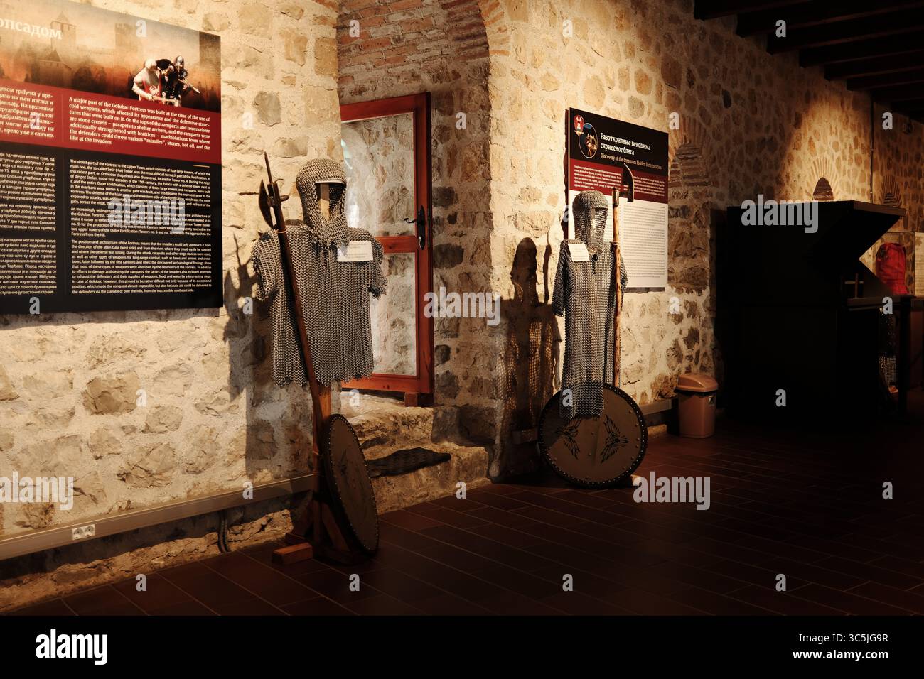Medieval chainmail armor and shields displayed in a museum room with ...
