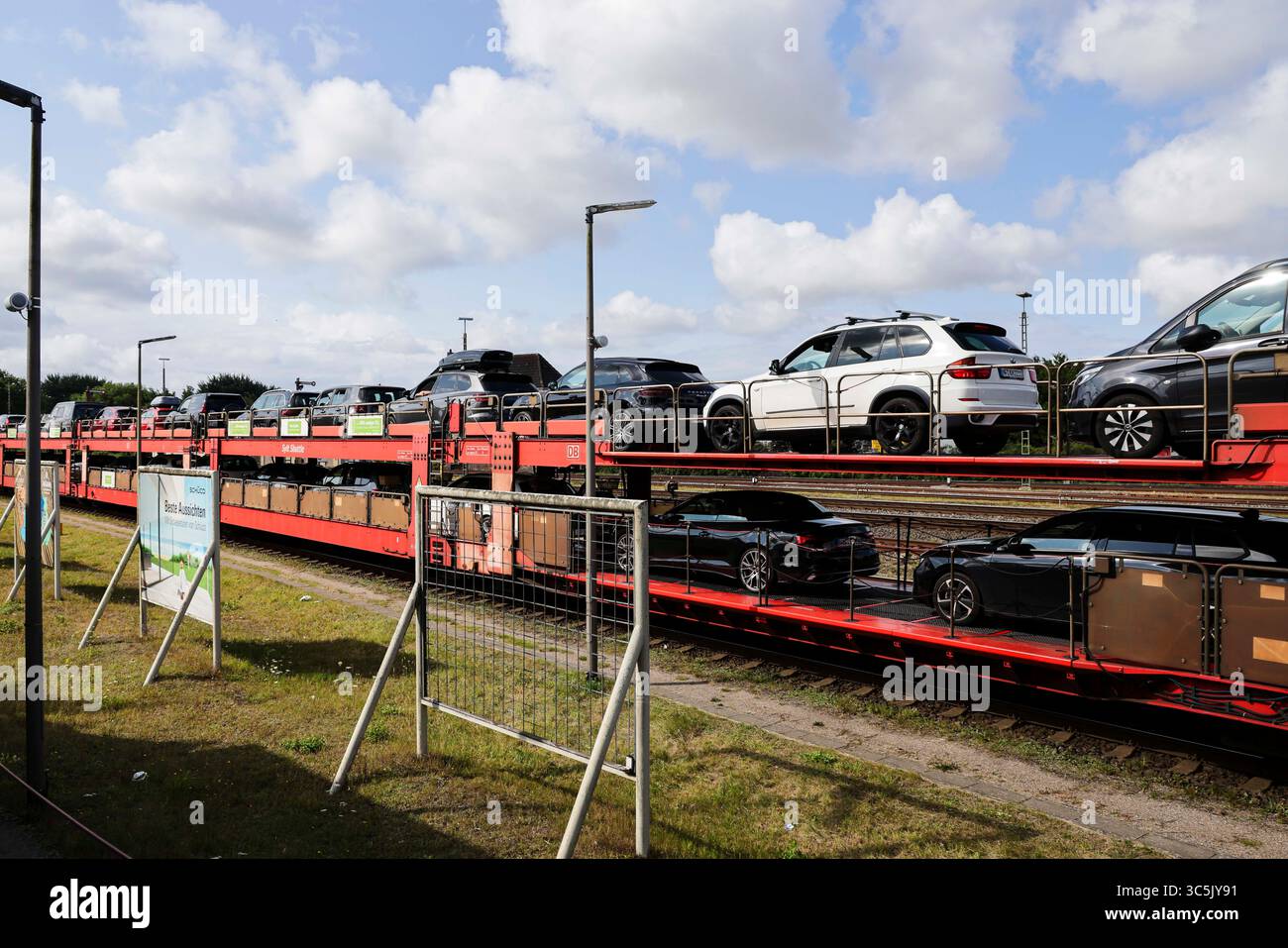 28 July 2025, Schleswig-Holstein, Niebüll: Cars stand on a car train to ...