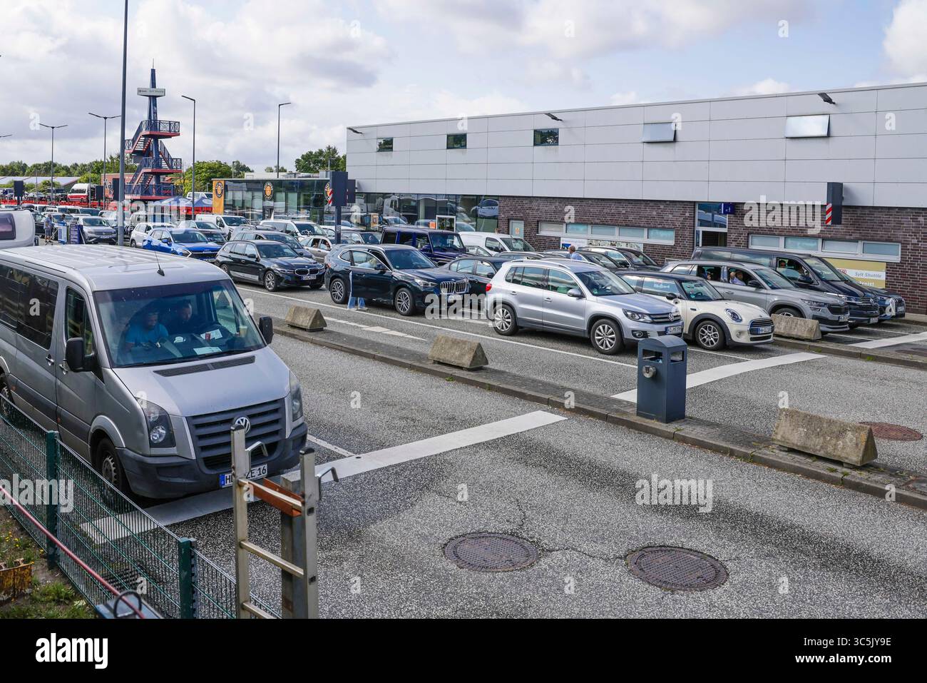 28 July 2025, Schleswig-Holstein, Niebüll: Cars waiting to be loaded ...