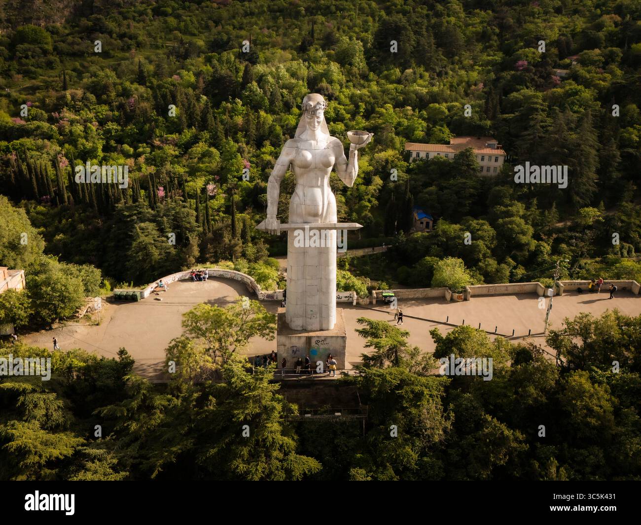 Aerial view of Kartlis Deda statue standing tall amidst the lush ...