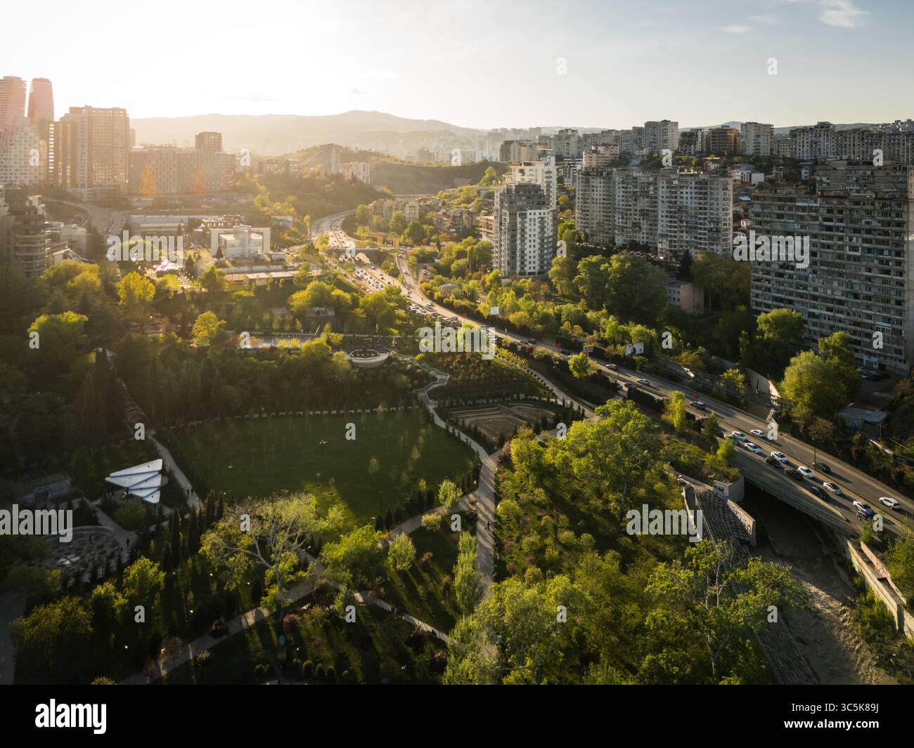 Aerial view of Mziuri Park's lush greenery meeting the city's ...